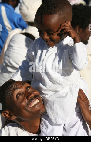 Ethiopian father carrying his son on his back during Timkat epiphany ...