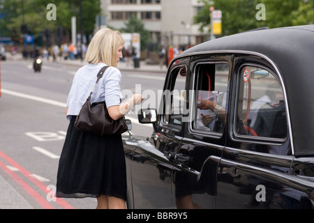 A woman London taxi driver in London in England in Great Britain in the ...