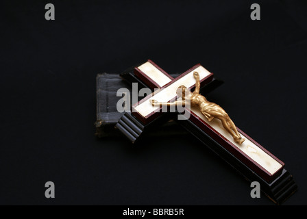 A holy Christian cross laying on an open Bible with an American flag ...