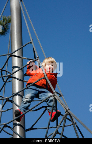 CLIMBING THE ROPES OF THE 'SPIDER'S WEB', JUNGLE GYM, CHILDREN'S ...
