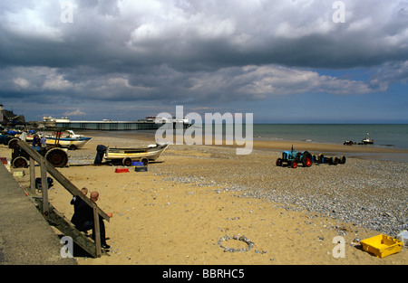 Cromer Beach, East of the Pier, with boats and tractors looking towards ...