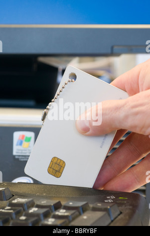 Computer access card being slotted into card reader built into laptop ...