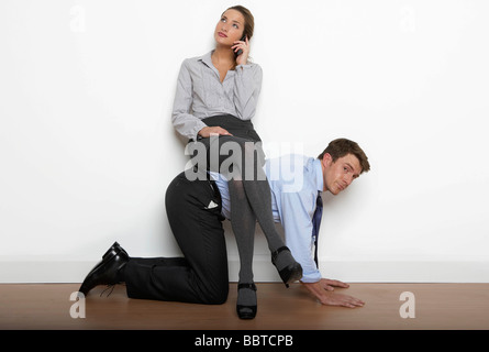 Business woman sitting on man's back Stock Photo: 24508386 - Alamy