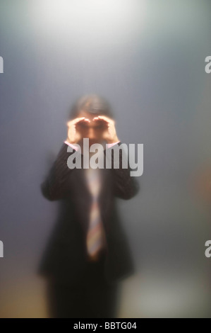 Man looking through frosted glass Stock Photo - Alamy