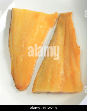 Two raw haddock fish fillets on kitchen table. Isolated on white ...