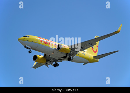 A low angle view of a TUI aircraft landing in stormy weather and ...