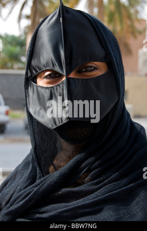 An Omani Bedouin woman wearing a traditional Batoola face covering ...