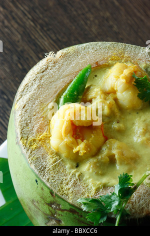 Dab chingri Malai Curry is made of prawns roasted inside a tender ...
