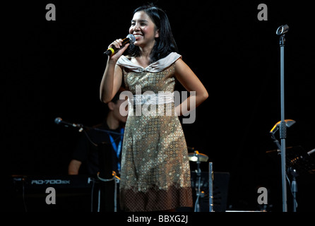 Female singer of the Indonesian band Mocca performing on stage at the ...