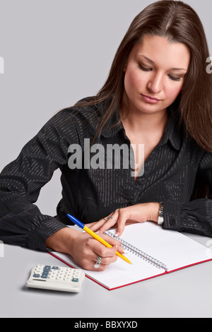 pen and calculator on the book Stock Photo - Alamy
