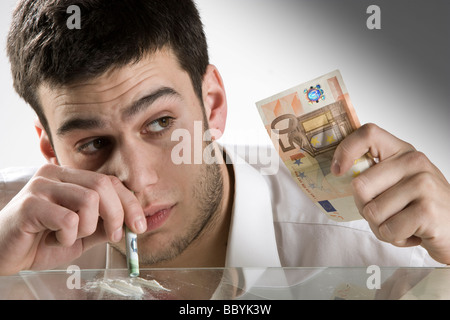 Guy smelling drug on the white background Stock Photo - Alamy