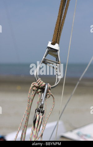 Trapeze ropes with pulley block from a sail boat on a beach Stock Photo ...