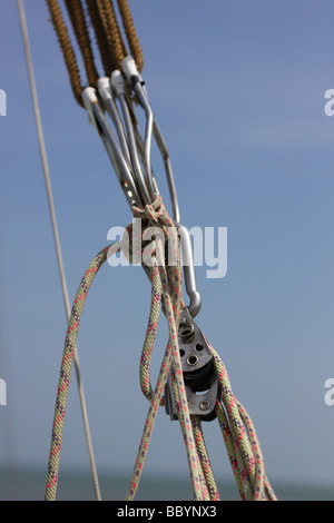 Trapeze ropes with pulley block from a sail boat on a beach Stock Photo ...