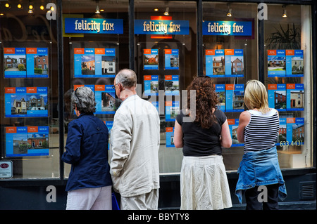 Estate agent with potential buyers in front of residential house Stock ...