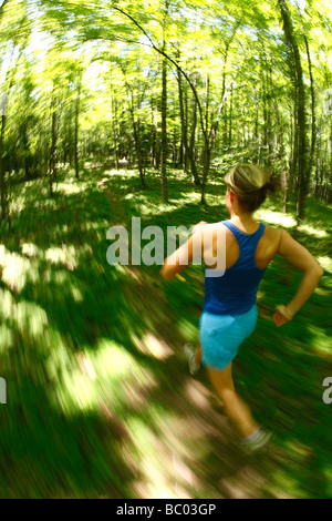woman running through the forest by the lake Stock Photo - Alamy