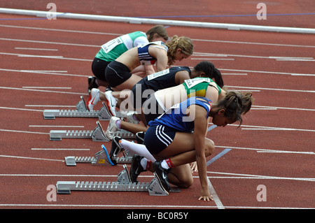 Sprinters at starting blocks ready for race . Athletes at starting ...
