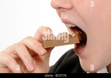 Schoolgirl eating a chocolate bar Stock Photo - Alamy