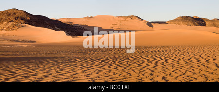 Panorama of wind eroded desert floor with ridges running into shot and ...