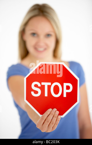Woman holding stop sign Stock Photo - Alamy