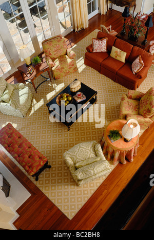 A Spacious living room with tall windows and hardwood floors Stock ...