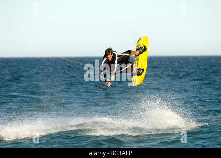 Surfer in action and catching some air after hitting the crest of a ...