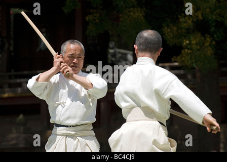 Two men sparring with wooden sticks in a swordsmanship training ...