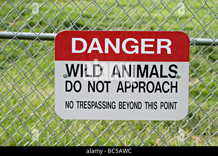 A sign at a zoo warning of dangerous animals Stock Photo - Alamy
