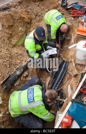 EDF workers repairing an electrical cable in the ground Stock Photo - Alamy