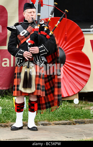 Piper Adorned in the Ramsay Tartan playing the Bagpipes pipes and are a ...