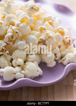 Popcorn on purple plate Stock Photo - Alamy