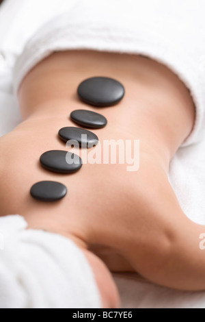 Woman having LaStone Therapy (healing therapy using stones Stock Photo ...