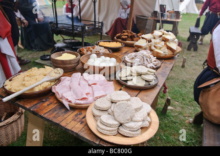 Table with a selection of typical medieval food including boiled ham ...