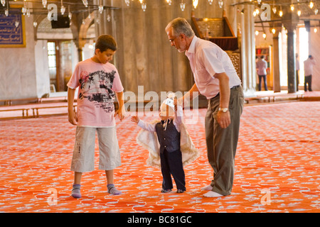TURKEY Istanbul Sultanahmet Young boy eating sweetcorn cooked on the ...