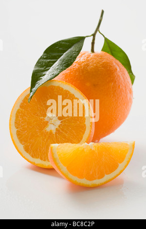 Orange with stalk and leaf, orange half and wedge Stock Photo - Alamy