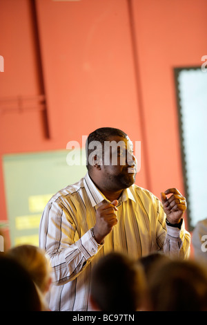 Primary school teacher leading a hands-on science activity with a group ...