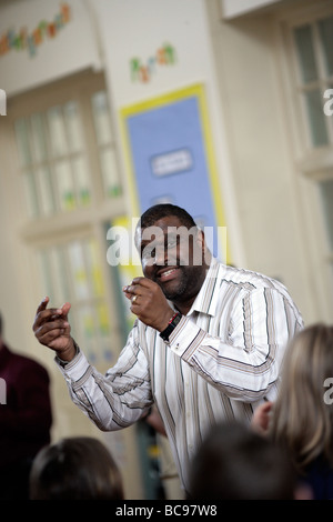 Primary school teacher leading a hands-on science activity with a group ...