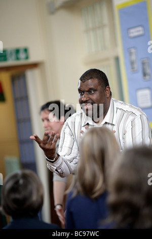 Primary school teacher interacting with students during a hands-on ...