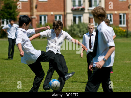 Schoolboys playing football during their lunchbreak. Soccer Stock Photo ...