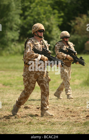 British army soldier with gun on a 40kg loaded march tab military ...
