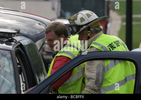 Two firefighters communicating at the scene of a fire Stock Photo - Alamy