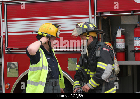 Firefighters communicating at a fire scene Stock Photo - Alamy