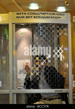 Smoking booth inside Vienna airport cafe, Austria Stock Photo - Alamy
