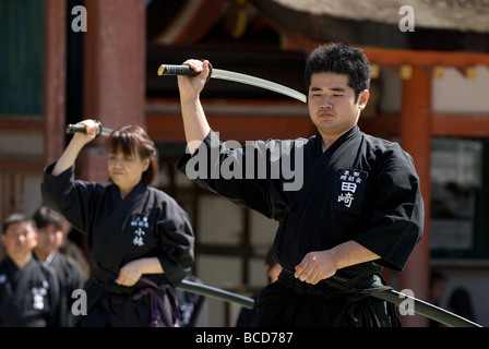 Two people using real samurai swords during a swordsmanship exercise ...