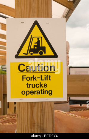 Caution sign warning of fork lift trucks in use Stock Photo - Alamy