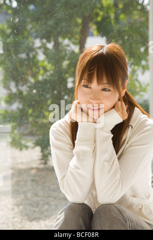 Young woman sitting near window and drinking tea Stock Photo - Alamy