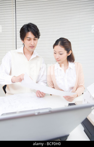 Young adult business woman working at computer in office smiling and ...