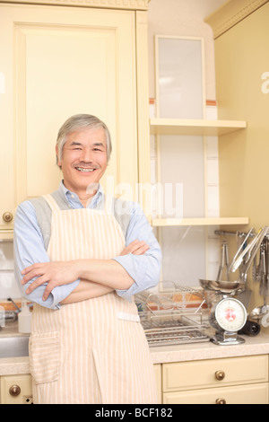 Smiling senior adult man standing outside in the garden Stock Photo - Alamy