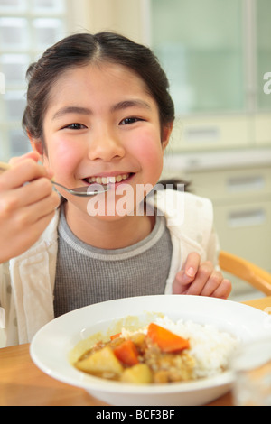 Girl eating rice Stock Photo - Alamy
