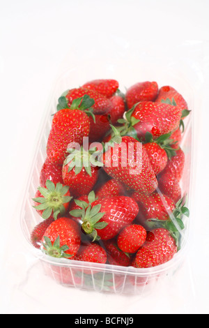 Ripe strawberries in a plastic package on a white background. Delicious ...
