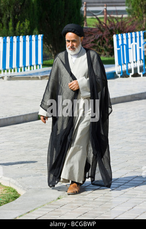 Shia Muslim mullah in turban and gown seated at prayer in the Masjed-e ...